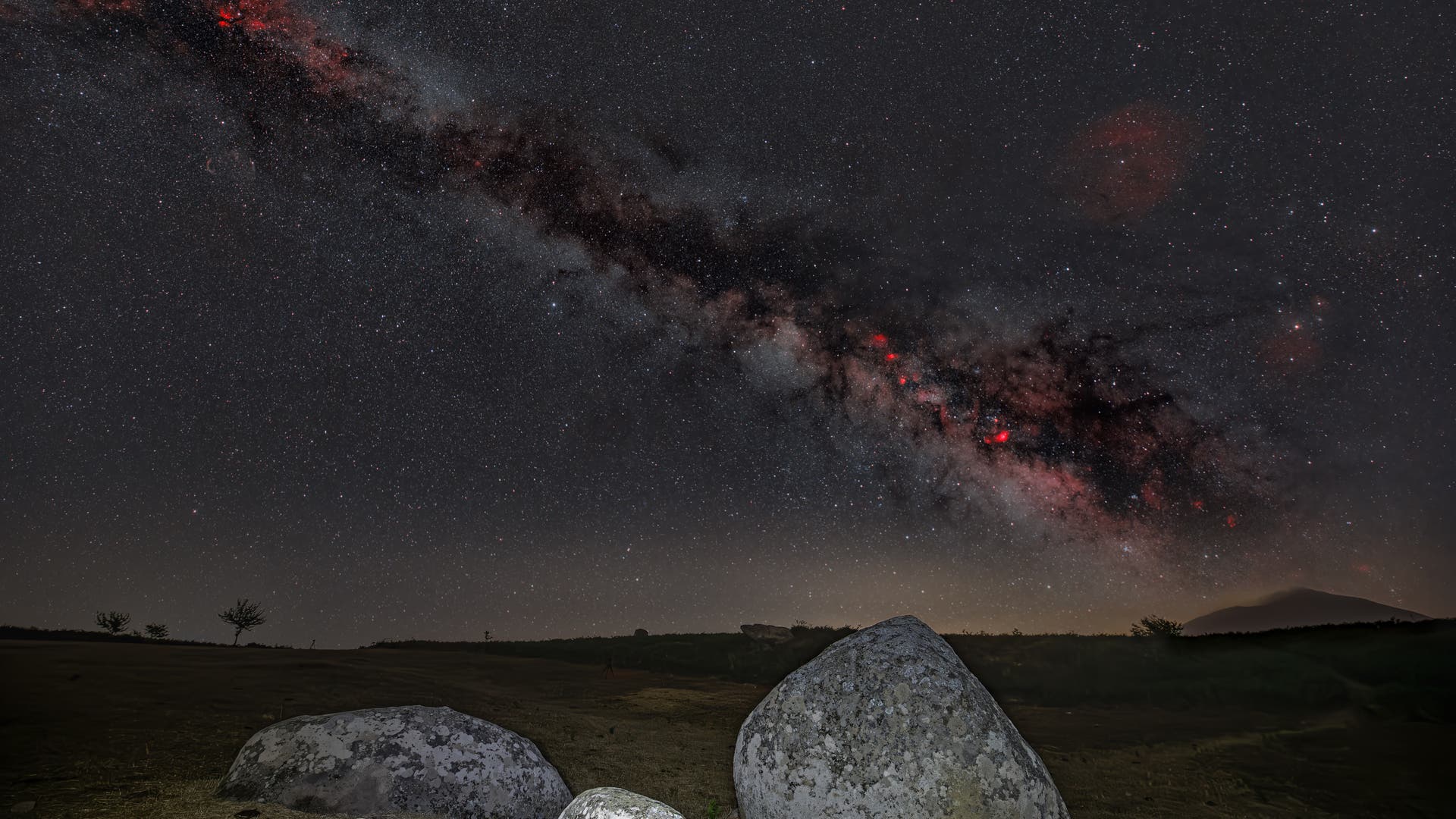 Milky way rises between the rocks of Argimusco plateau and Etna ...