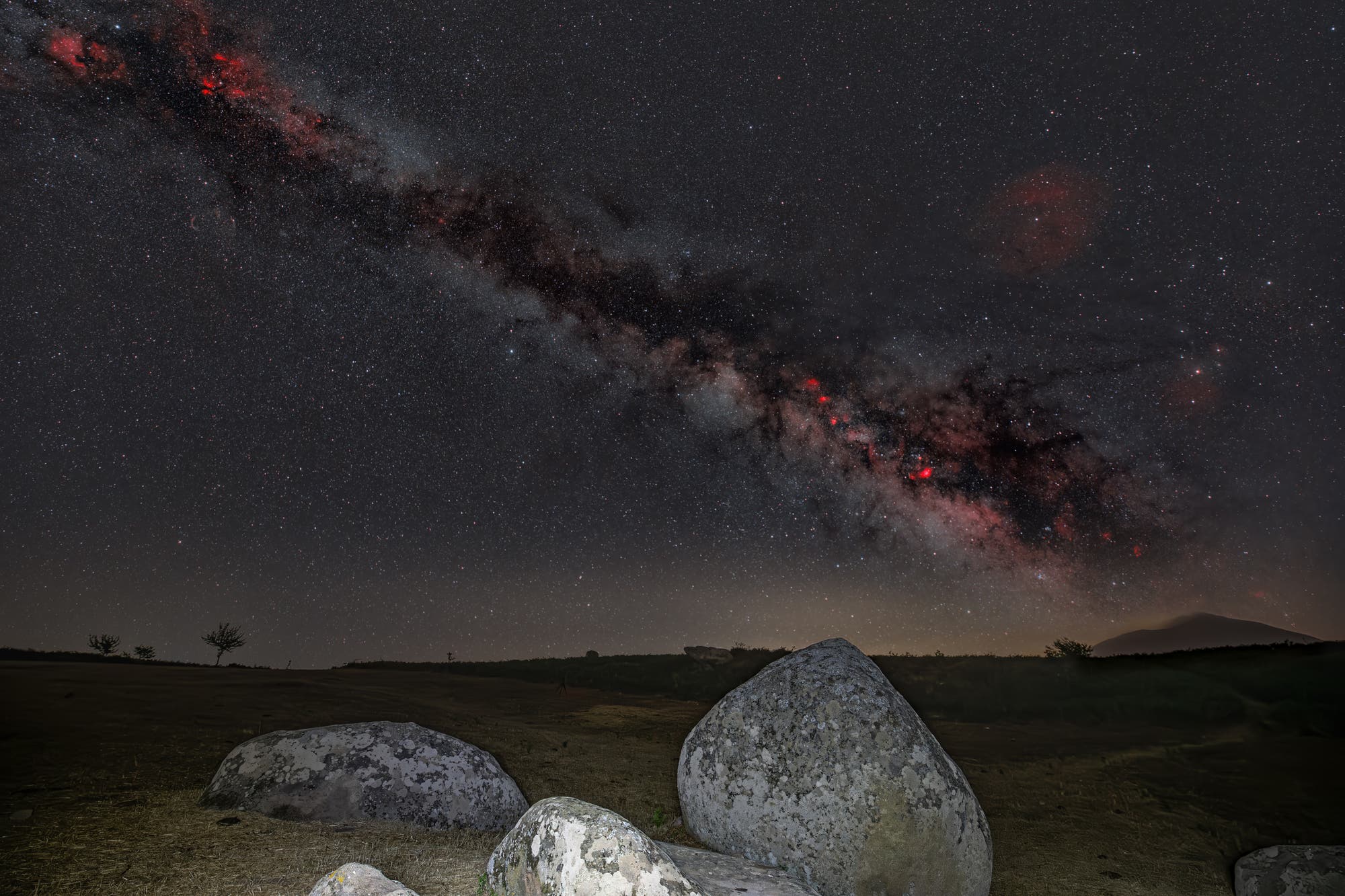 Milky way rises between the rocks of Argimusco plateau and Etna ...
